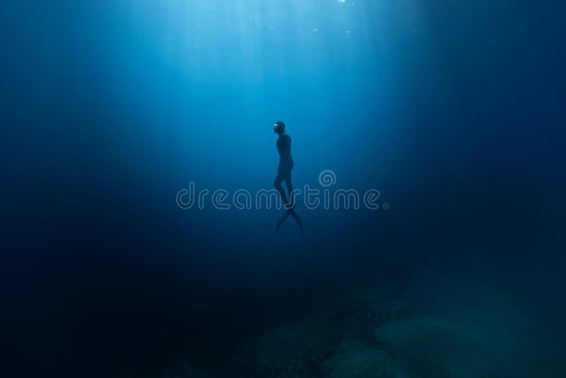 Freediver Swimming in Deep Sea with Sunrays Stock Image - Image of ...