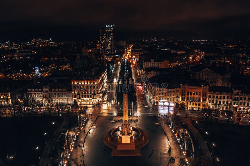 Freedom Monument Surrounded by Buildings and Lights at Night in Riga ...
