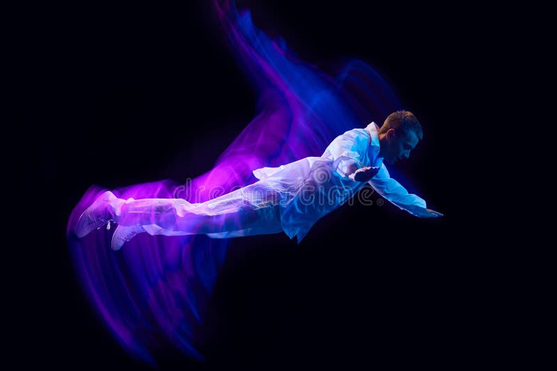 Freedom. Young Guy in Stylish Clothes Falling Down Against Black Studio ...