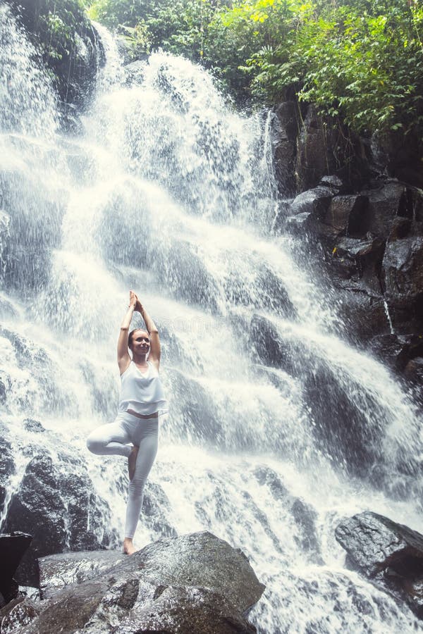 Yoga on the waterfall stock photo. Image of gymnastics - 101944208