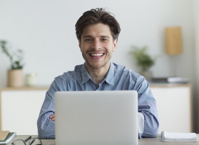 Freelance Guy Smiling at Camera Sitting at Laptop in Office Stock Image ...