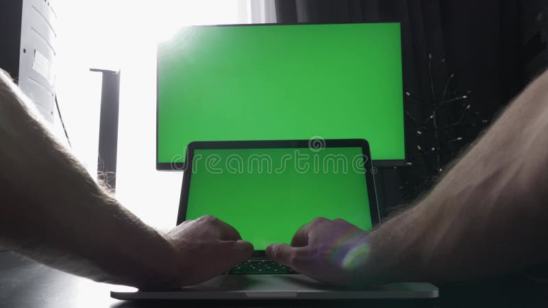 Freelance it Man is Working Online on Laptop with Green Screens. Male ...