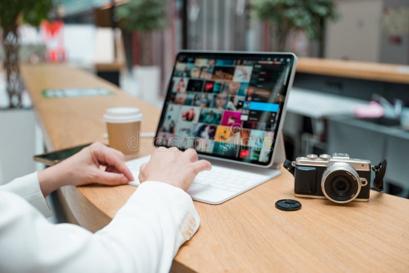 A Freelance Photographer Works Remotely, a Thin Mobile Computer with a ...