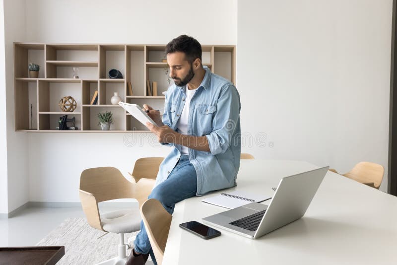 Young Man Remote Worker Reviewing Paper Documents at Home Office Stock ...
