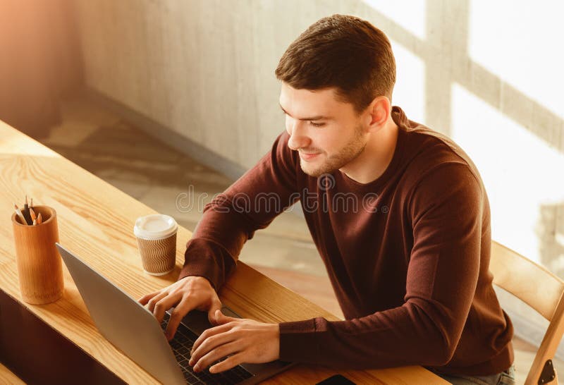 Copywriter Man Working at Laptop Computer in Modern Office, High-Angle ...