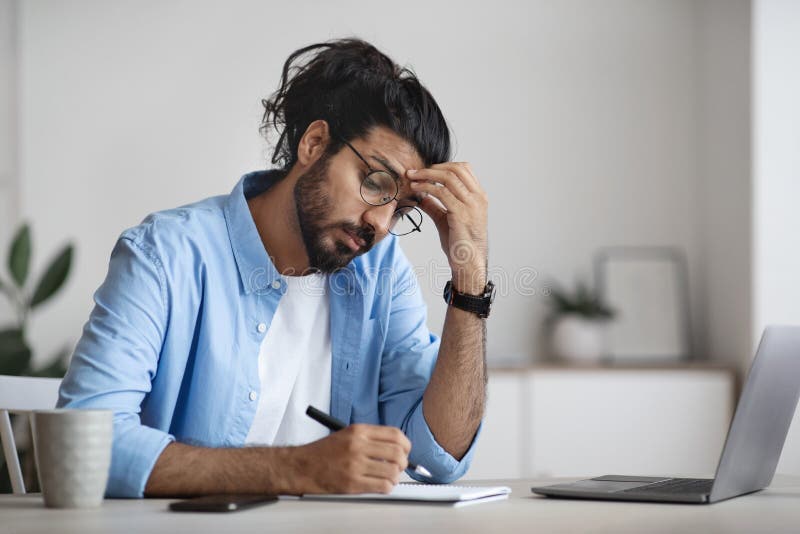 Freelancer Guy Taking Notes To Notepad while Working at Home Office ...
