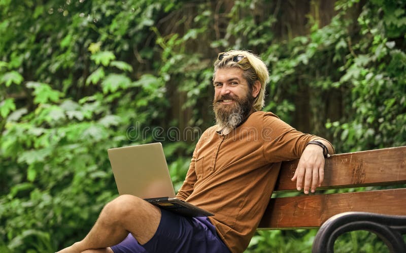 Freelancer Man Working on Computer. Businessman Using Notebook in Park ...