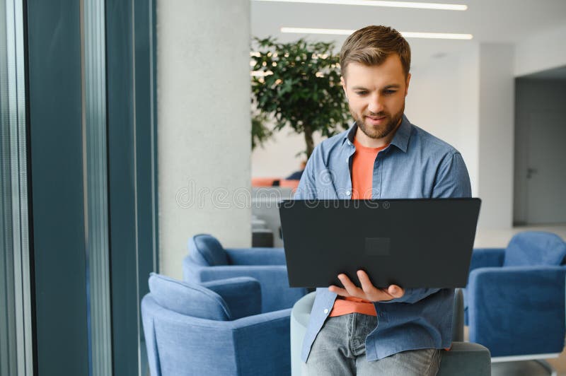 A Freelancer Man Works with a Laptop in a Work Coaching Office Stock ...