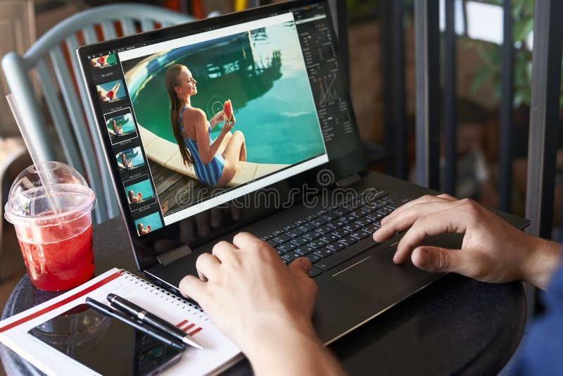 Freelancer Retoucher Man Works at the Laptop Computer with Photo ...