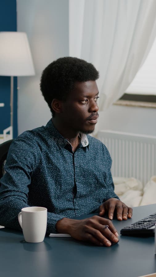 Freelancer Taking Notes on Notepad and Looking into Computer Stock ...