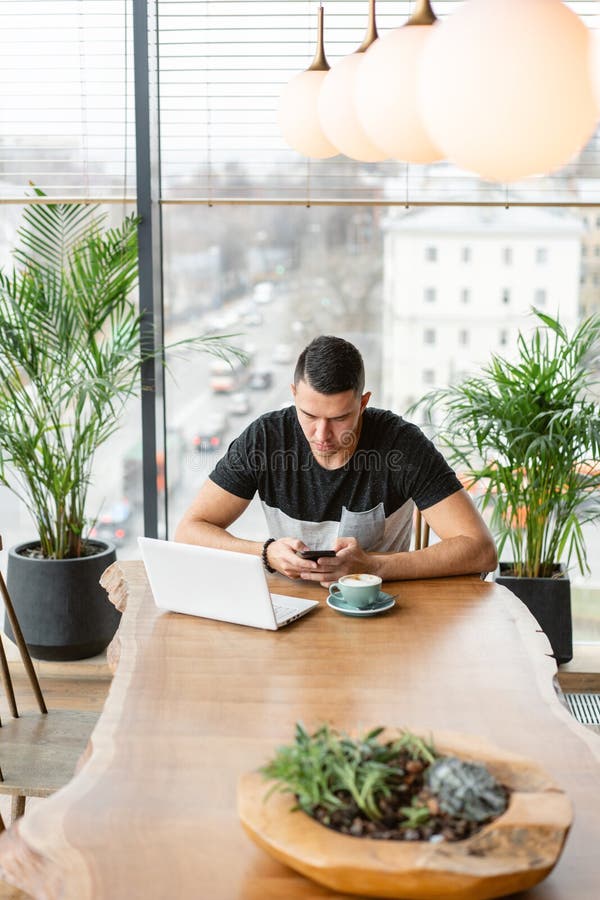 Freelancer Work on Netbook in Modern Coworking. Young Man Drinking ...