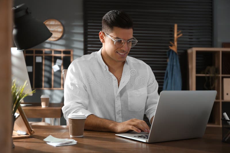 Freelancer Working on Laptop at Table Indoors Stock Image - Image of ...