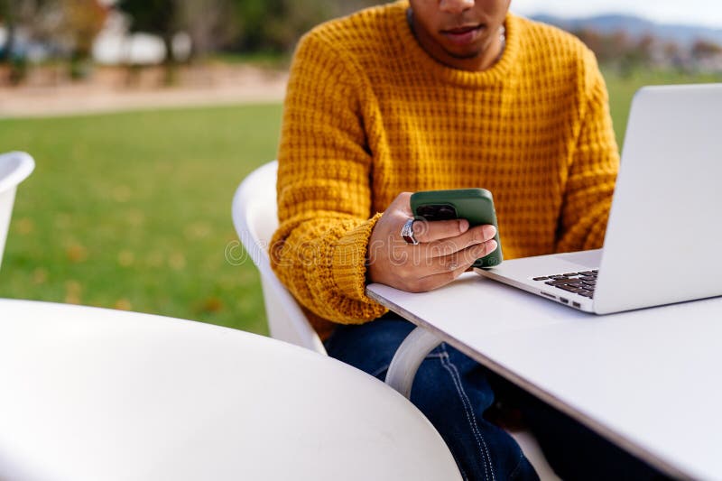 Freelancer Working Remotely Using Laptop and Smart Phone in Park Stock ...