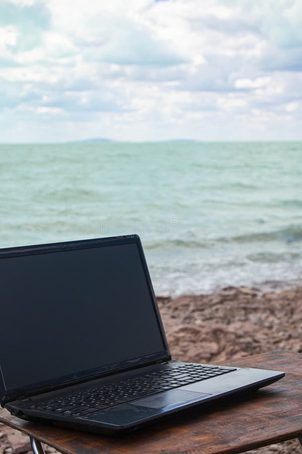 Freelancer Workplace on the Sandy Beach with a Computer on the Table ...
