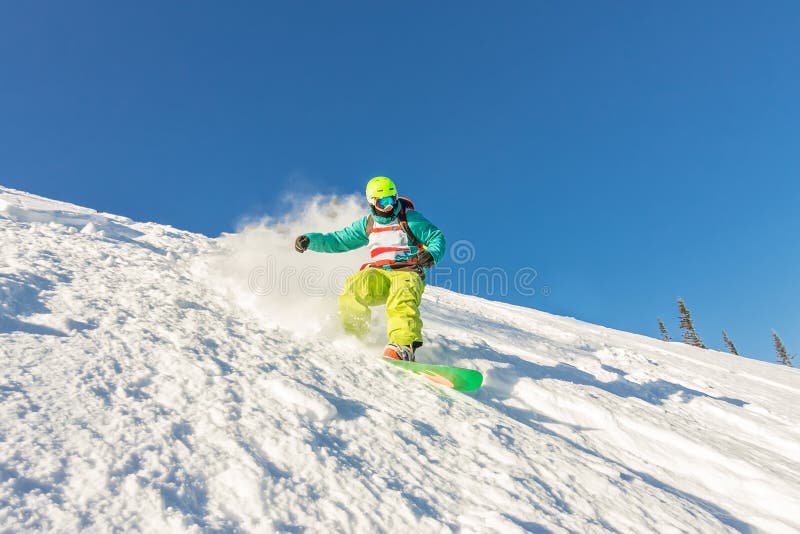 Freeride Snowboarder Slides Down a Steep Slope at Dawn Stock Photo ...