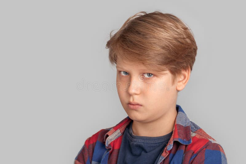 Freestyle. Young Boy Standing Isolated on Grey Looking Camera Serious ...