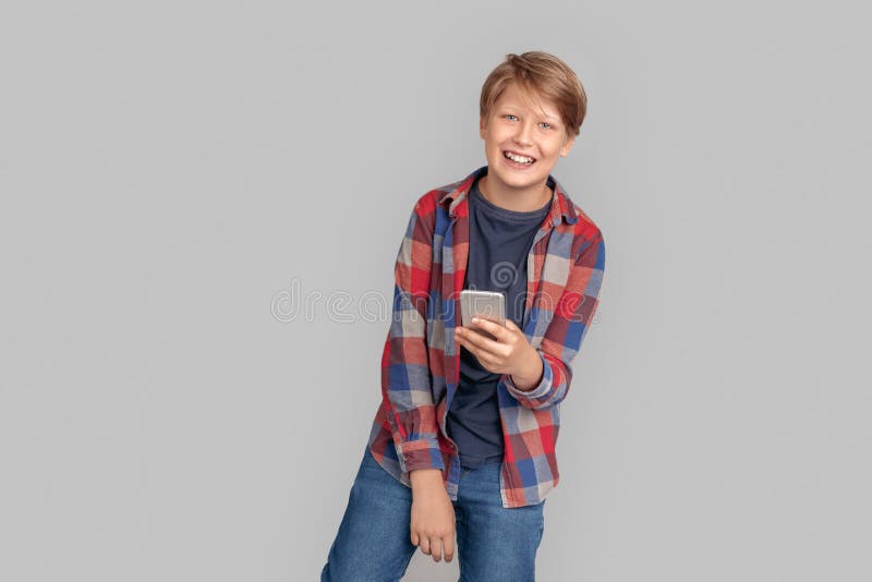 Freestyle. Young Boy Standing Isolated on Grey Taking Selfie Posing To ...