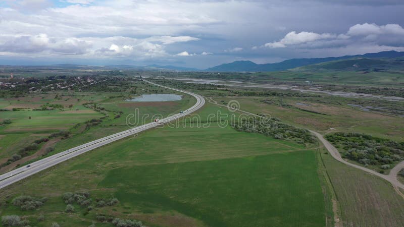 Freeway among green fields stock image. Image of asphalt - 148403757