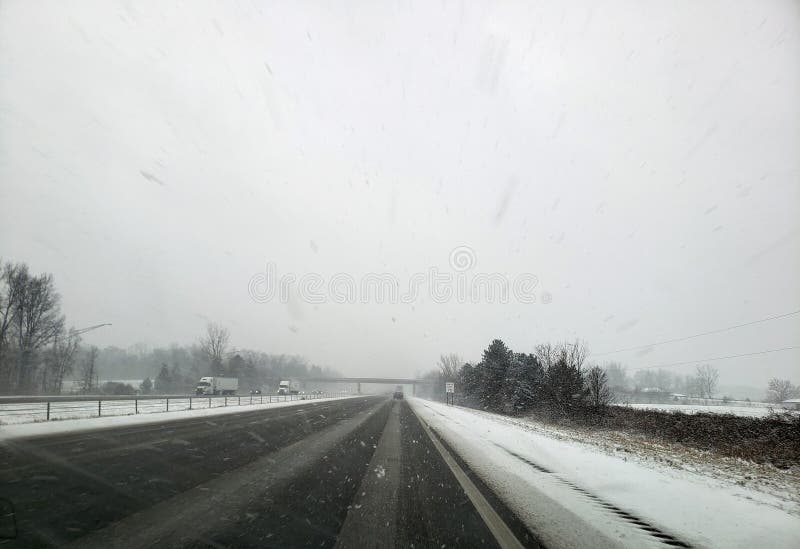 Freeway during a Winter Snowfall Stock Photo - Image of light, journey ...