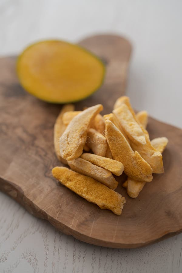 Freeze-dried Mango with Fresh One on Olive Wood Board Stock Image ...