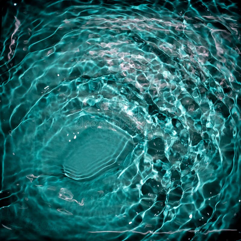 A Freeze Frame of Water on a Blue Background, with Ripples Spreading ...