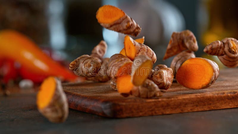 Freeze Motion of Falling Raw Turmeric on Cutting Board Stock Image ...