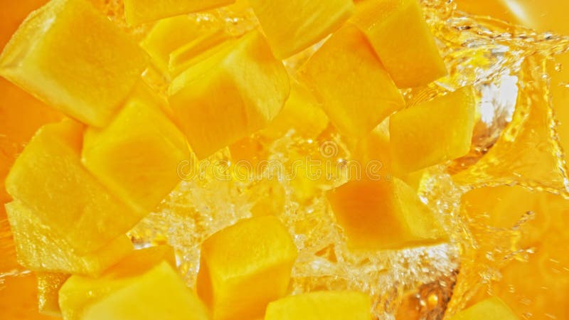 Freeze Motion of Flying Mango Slices into Water, Colored Background ...