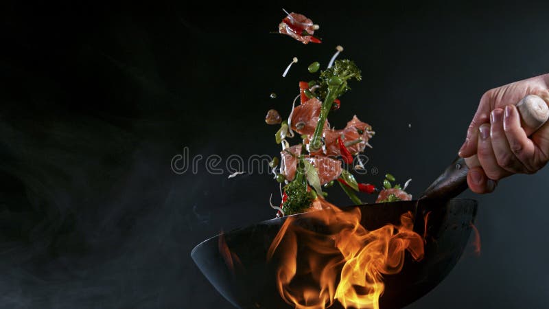 Freeze Motion of Wok Pan and Flying Ingredients in the Air. Stock Image ...