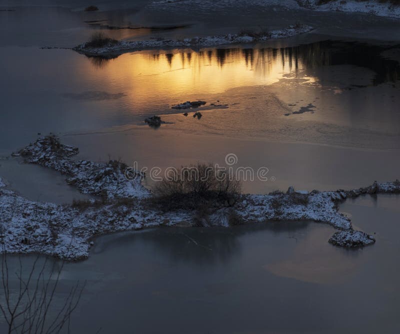 Freezing Lake at Sunset on a Winter Evening. Trees and Sunlight are ...
