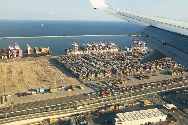 Freight Cargo Ship Loading on a Harbour Seen from an Airplane Wing ...