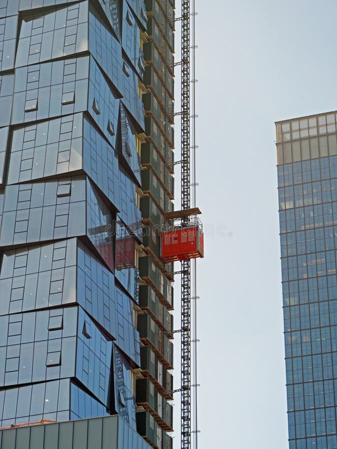 Freight Construction Elevator Ascends To Top of a Skyscraper. Temporary ...