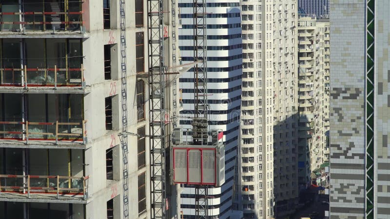 Freight Elevator at the Construction Site of a Tall Building Rides Up ...