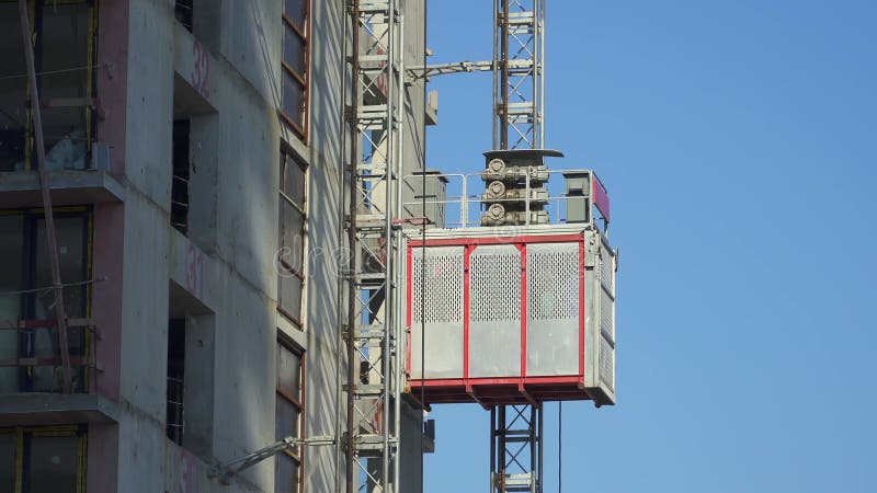 Freight Elevator at the Construction Site of a Tall Building Rides Up ...