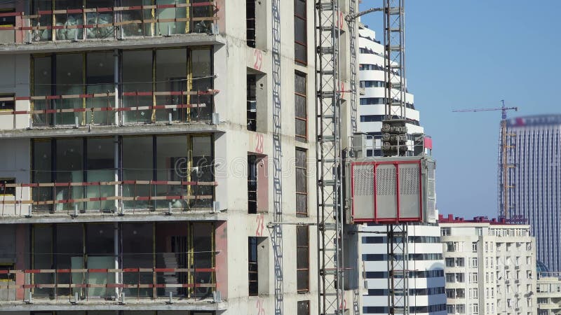 Freight Elevator at the Construction Site of a Tall Building Rides Up ...
