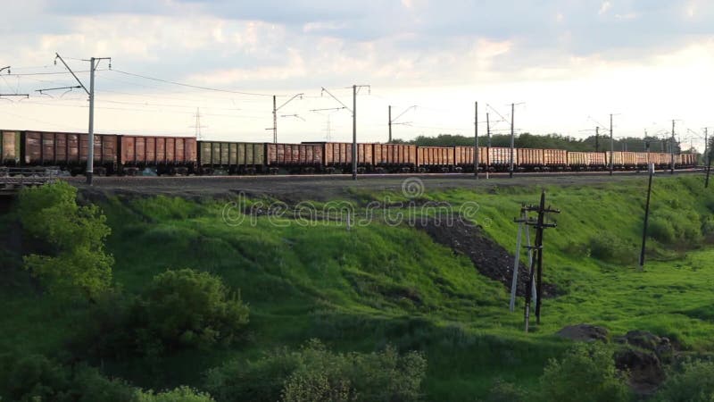 Freight Train Carriages Passing on a Railroad Track at Sunset Stock ...