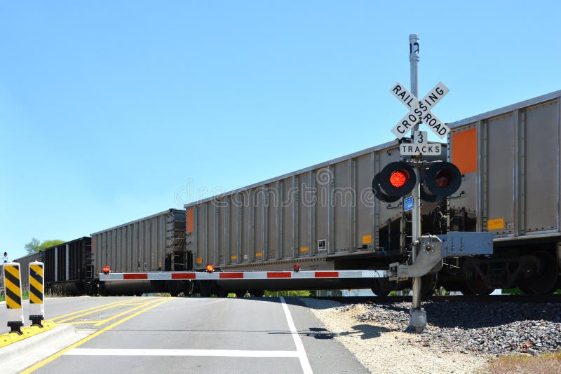 Freight Train at Crossing Gate Stock Image - Image of road, metal: 92126477