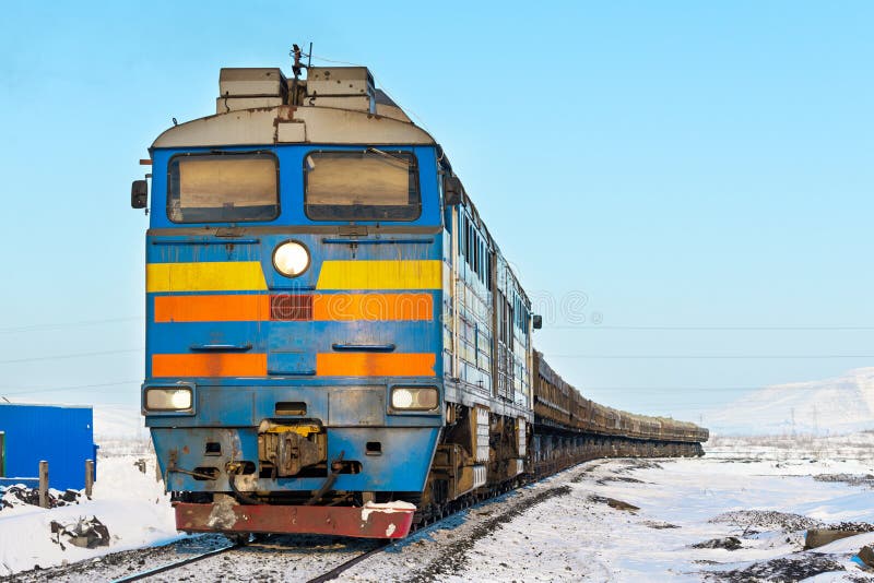 Freight Train Moving on Snow-covered Tracks. Stock Photo - Image of ...