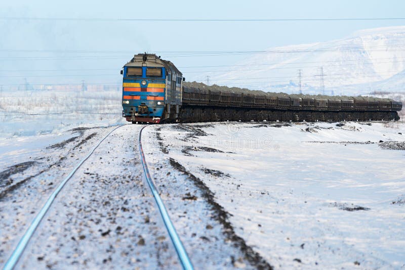 Freight Train Moving on Snow-covered Tracks. Stock Image - Image of ...