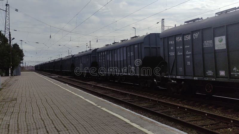 Freight Train Passes by the Railway Station and Leaves Stock Photo ...