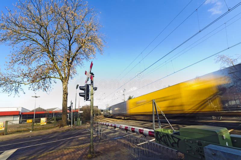 Freight Train at a Railroad Crossing Stock Photo - Image of street ...