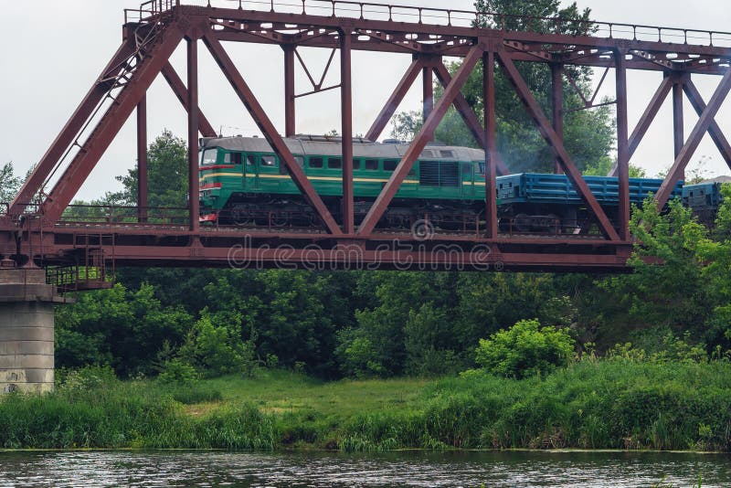 Freight Train Rides on a Railway Bridge Over the River Stock Photo ...