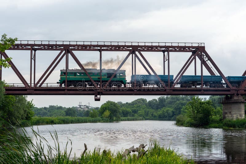 Freight Train Rides on a Railway Bridge Over the River Stock Image ...
