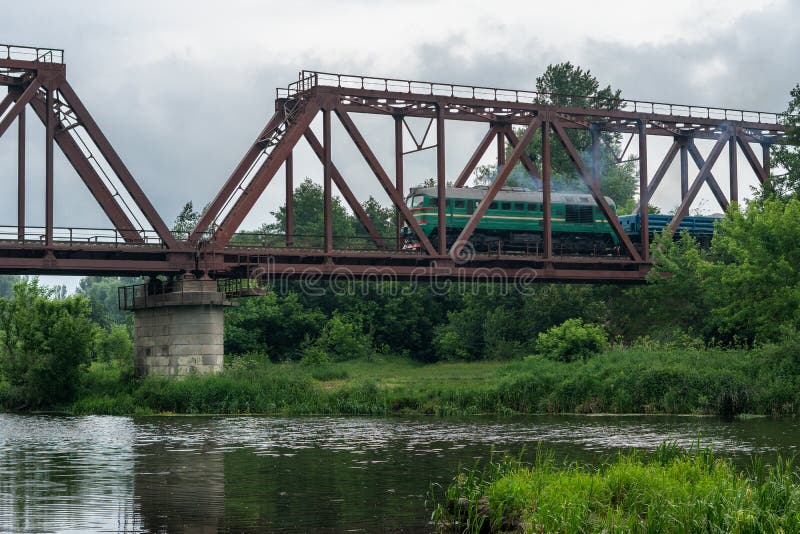 Freight Train Rides on a Railway Bridge Over the River Stock Image ...