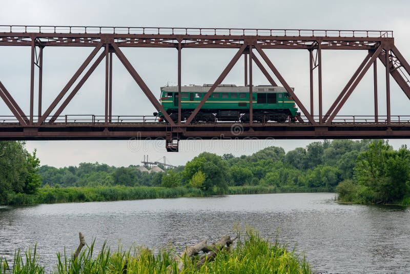 Freight Train Rides on a Railway Bridge Over the River Stock Image ...