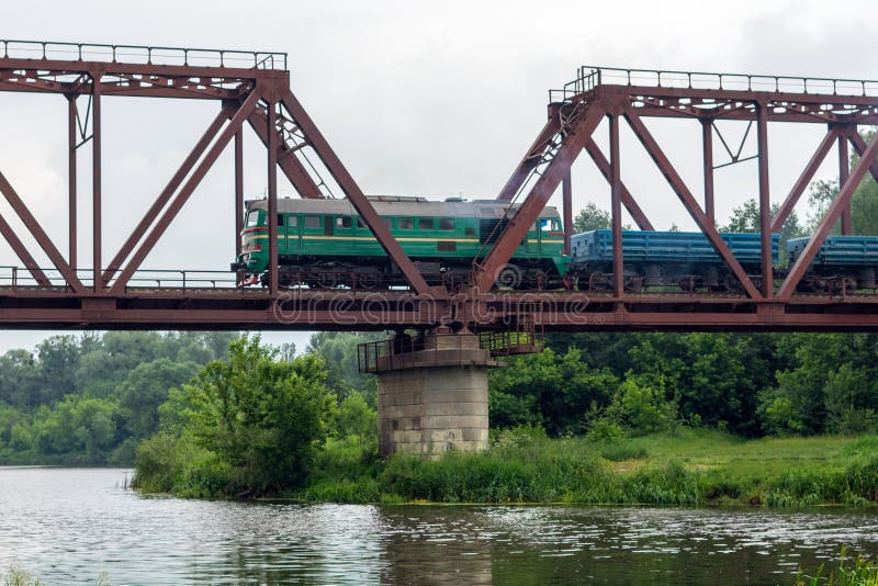 Freight Train Rides on a Railway Bridge Over the River Stock Image ...