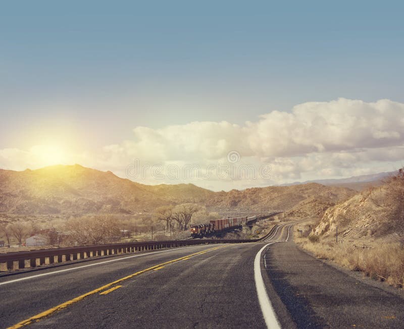 Freight Train Running on Track Alongside a Highway Stock Image - Image ...