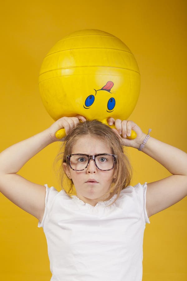 Freighten Look of a Young Girl with a Yellow Ball Stock Image - Image ...