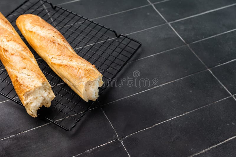 French Bread Baguette on a Steel Rack. Black Background Stock Image ...