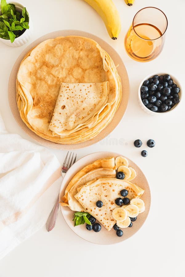 French Crepes with Banana and Blueberries on White Table. Top View ...