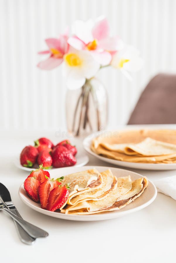 French Crepes with Chocolate Spread and Strawberries on White Table ...